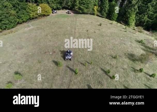 Aerial drone view of ATV quads on a dirt trail in forests. Off-road ...