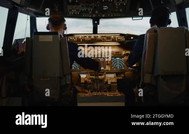 Captain and copilot throttling engine handle to fly airplane, taking ...