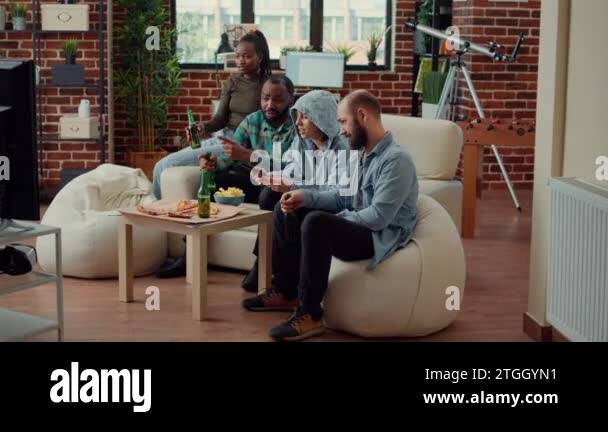 Multiethnic group of people watching television and switching channels ...