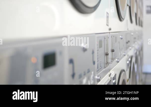 Row of washing and drying machines, public coin laundry in California ...