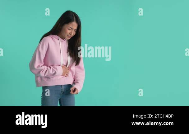Sick asian girl clasping belly while having stocmach-ache isolated on ...