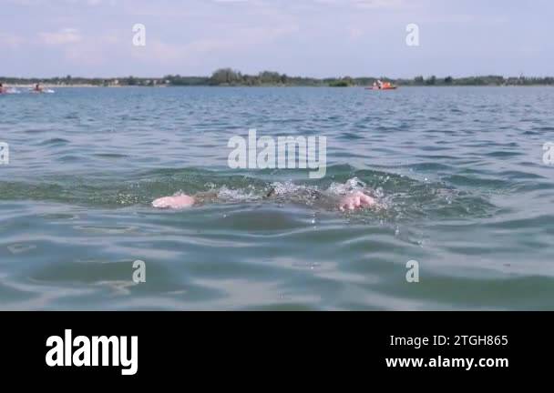 A Child Swimming, Drowning, Splashing Hands, Diving Under Water on the ...