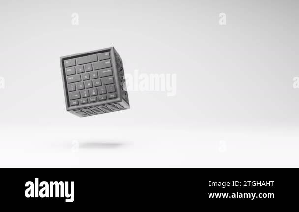 Cube Shape with Computer Keyboard on Faces Spinning on a Studio Light ...