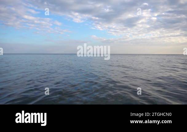 Slow motion submerging down underwater in smooth ocean waves at ...