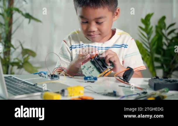 Little child trying assemble build wheel to car toy, Asian kid boy ...