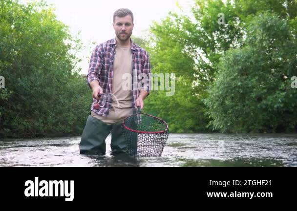 Fisherman with fishing rod on the river. Brown trout fish. Summer ...