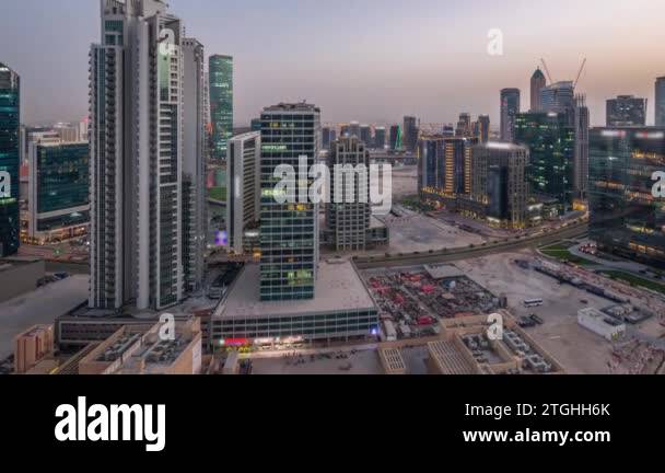 Business Bay Dubai skyscrapers with water canal aerial day to night ...
