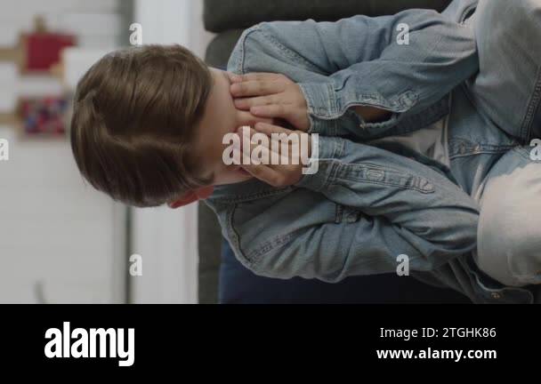 A scared, bored, worried child at home alone biting his fingers.He ...