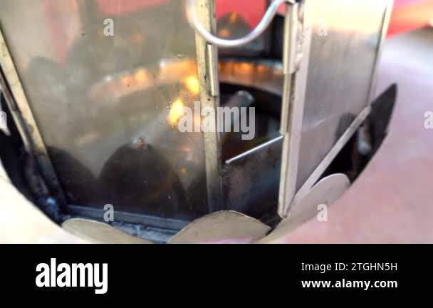 The old lamp glows from the fire. A transparent, glass lamp hangs in ...