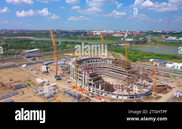 Sports stadium building carcass with machinery at construction site on ...