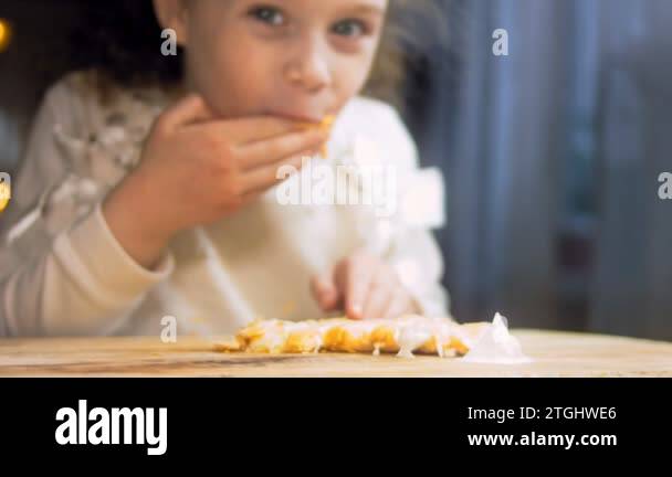 Puff pastry with cream. The cake is round in shape. The girl is eating ...