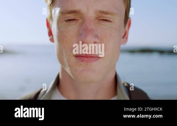 Face, beach and man with freckles in summer with focused mindset while ...