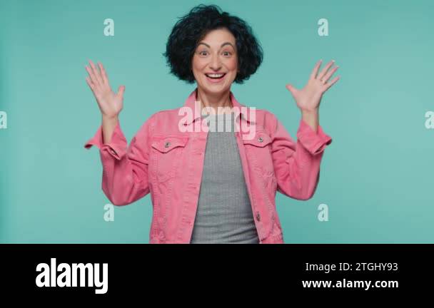 Gorgeous mature smiling woman with short dark curly hair clapping and ...