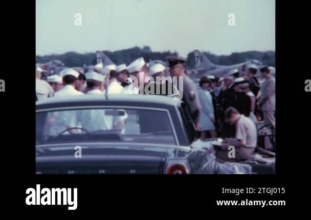 US Navy sailors in uniform with civilians at a military airport ...
