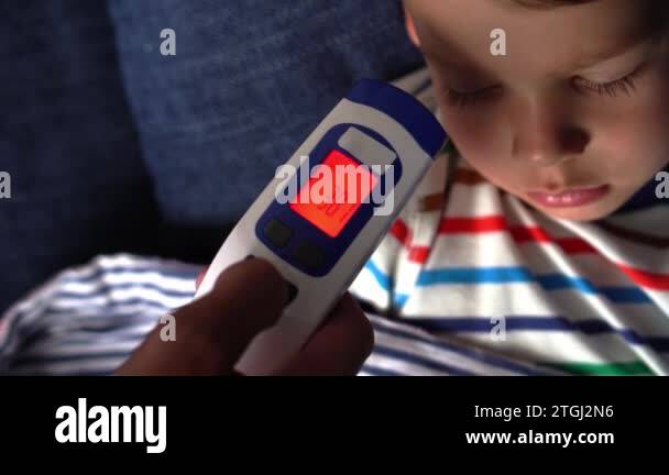 Portrait of sick ill little preschool child boy. Measuring body Hight ...