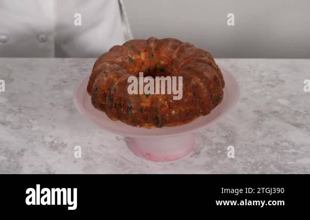 cooling down funfetti bunt cake with pink buttercream icing Stock Video ...