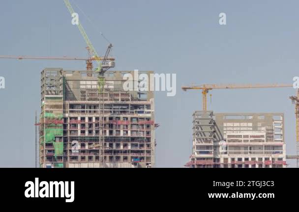 Cranes working on constraction site works of new skyscrapers timelapse ...