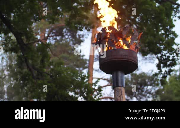 Crown on a pillar with fire. Close-up of a fire on a pole. A ...