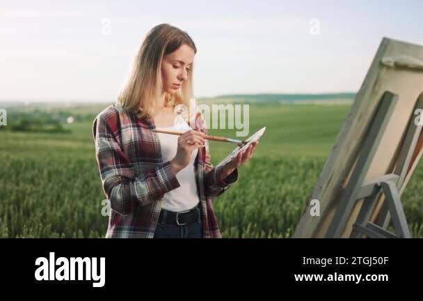 Side view of seductive, blonde woman holding brush and color palette ...
