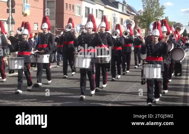 Marching band wearing helmets and costumes playing trumpets and drums ...
