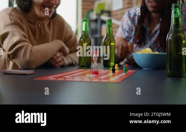 Diverse group of friends playing charades board games and fun gathering ...