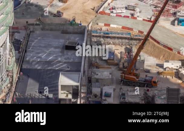 Cranes and bulldozers working at construction site of new skyscraper ...