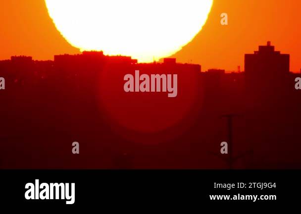 Sunset sun setting behind American downtown skyline silhouette. Epic ...