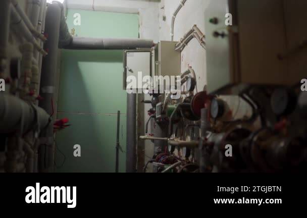 Electrician inspecting control panel with multimeter in a district ...