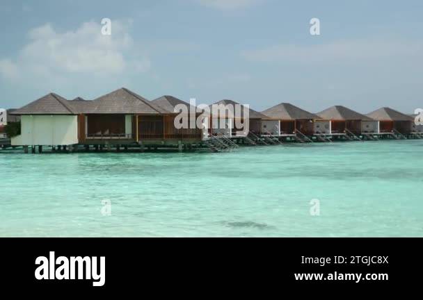 Luxury water villas bungalows or overwater villas on blue lagoon, white ...