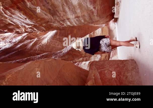 Vertical banner Tourist in Petra walk explore The Siq, the narrow slot ...