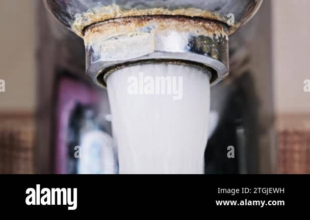 Faucet with running water in Slow Motion, macro shot. A jet of water ...