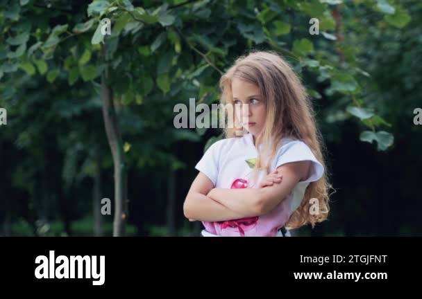 Sad emotions of a child girl. A smile on the face and a sign of ...