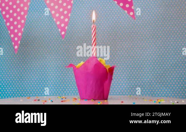 Happy birthday pink muffin with burning candles. Happy birthday ...