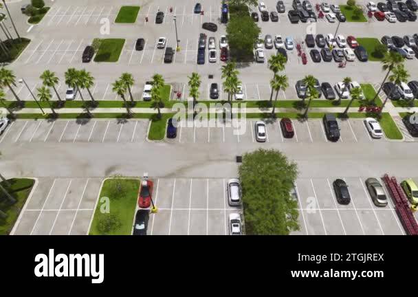 Aerial view of large parking lot with many parked colorful cars ...