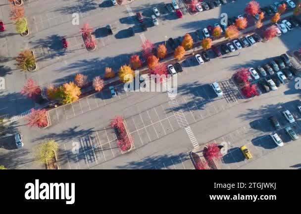 Aerial view of large parking lot with many parked colorful cars ...