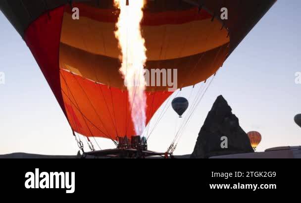 Movements of strong flame rising and inflating balloon. Preparing a hot ...
