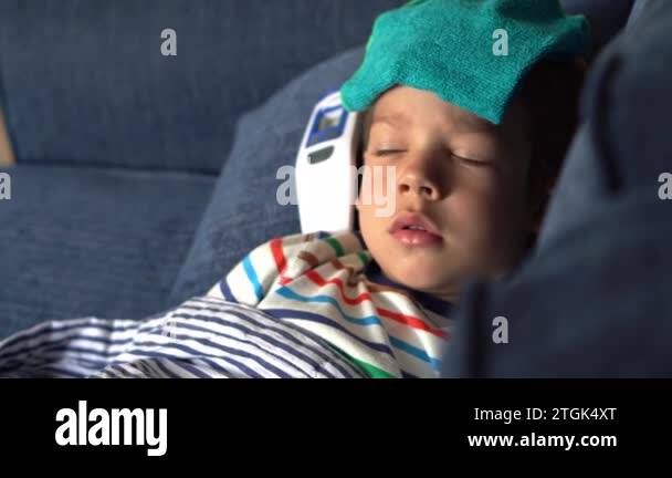 Portrait of sick ill little preschool child boy. Measuring body Hight ...