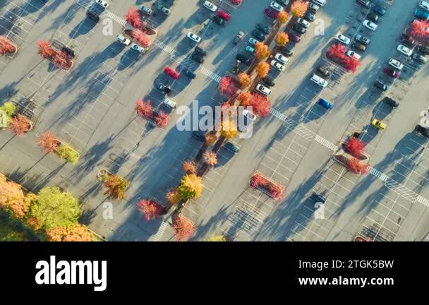 Aerial view of large parking lot with many parked colorful cars ...