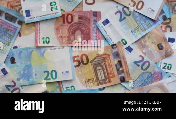 Euro banknotes in various denominations. Pile of banknotes on the table ...
