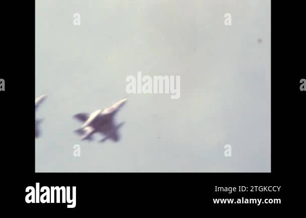 Pair of jet fighters with external tanks fly over airport and break ...