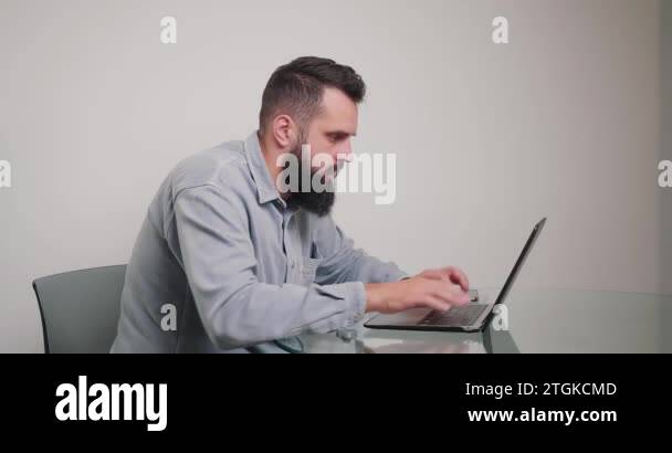 Man types on keyboard feeling irritated of laptop lagging during work ...