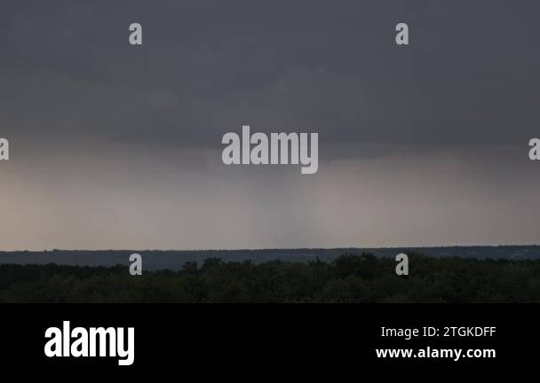 Lightning flash in storm clouds. Heavy clouds bring multiple flashes of ...