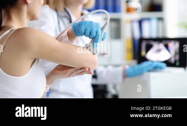 The doctor makes an ultrasound of the arm vessels, close-up, slow ...