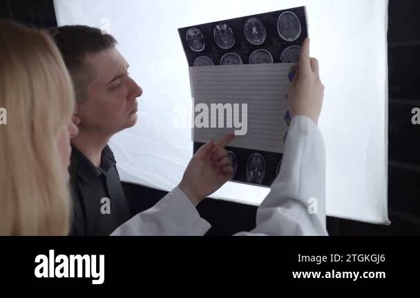 Epileptologist examines patient MRI and electroencephalogram. Concept ...
