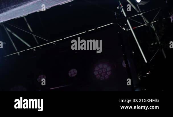 flashing and rotating light beams from stage lights on a construction ...