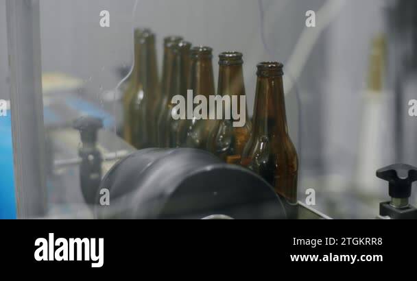 Capping process of full beer bottles. Machine for capping bottles ...