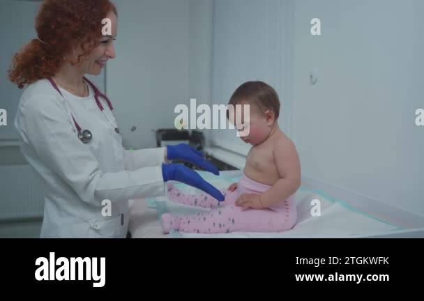 Little girl at doctor for checkup. Doctor pediatrician and baby patient ...