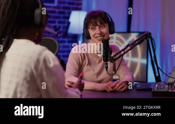 Closeup of online radio host recording interview with african american ...