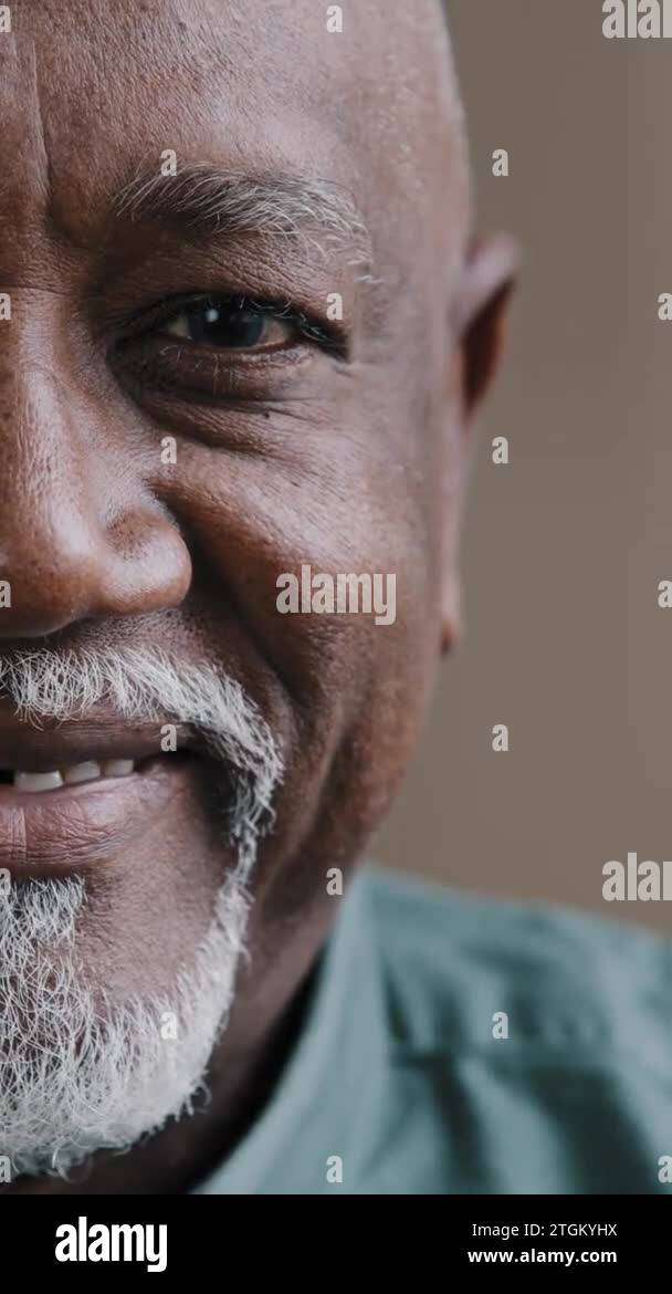 Extreme close up half face vertical view smiling old wrinkled male with ...