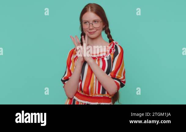 Sneaky cunning girl with tricky face gesticulating and scheming evil ...